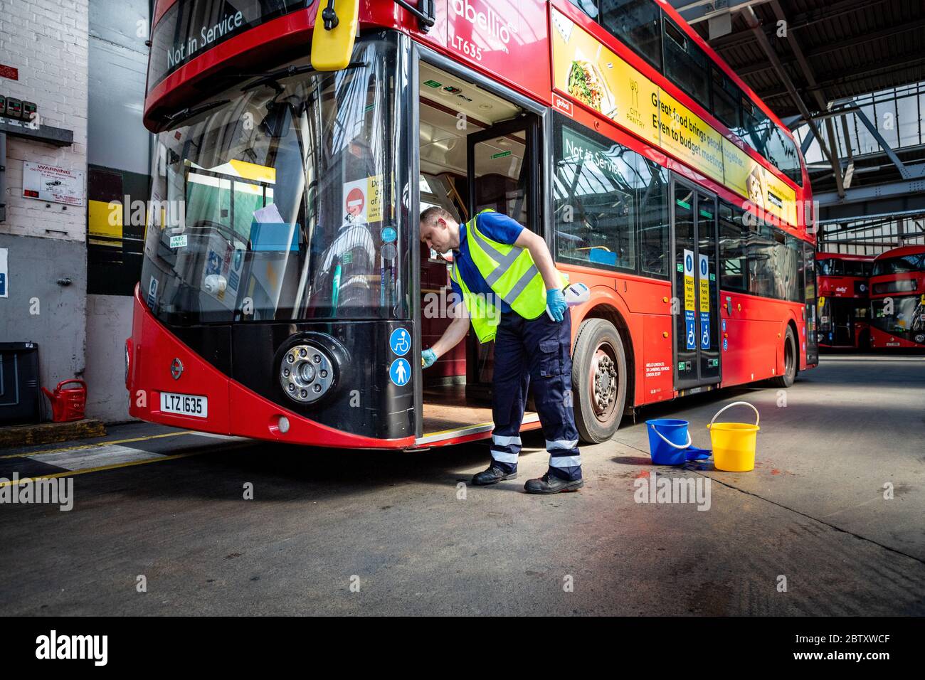 A bus is given a daily cleaning by a cleaner at Camberwell bus garage ...