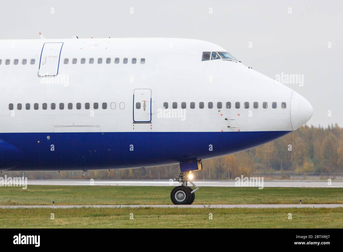Modern passenger double-decker airplane is taxiing to take off. Wide ...