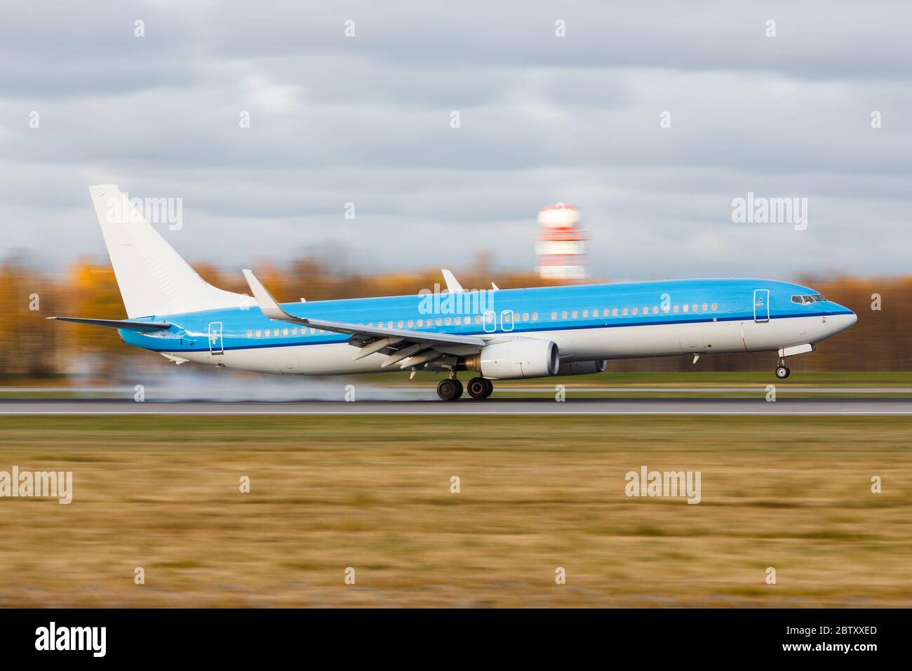 Narrow-body modern passenger airplane landing with touchdown on the ...