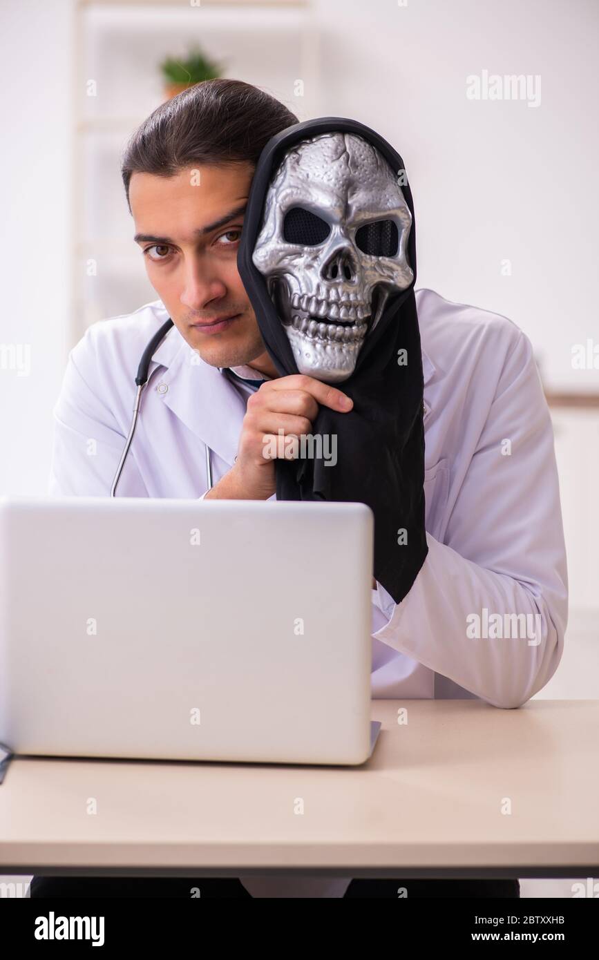 Male devil doctor working in clinic Stock Photo - Alamy
