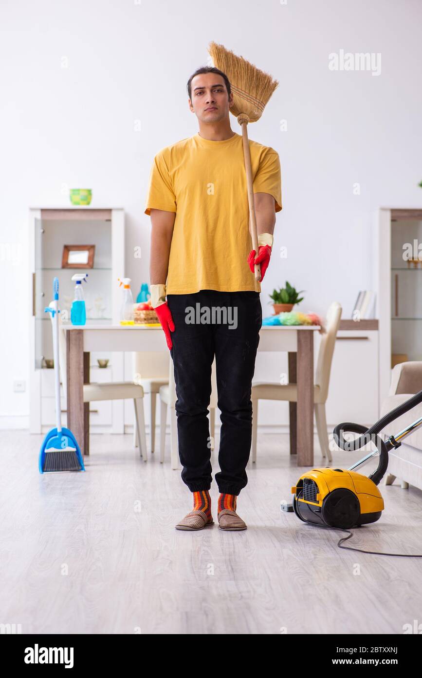 Young contractor cleaning the house Stock Photo - Alamy