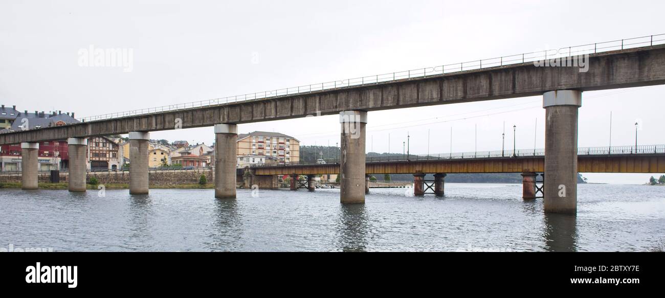 The railway bridge, (nearer) and the road bridge crossing the river in ...