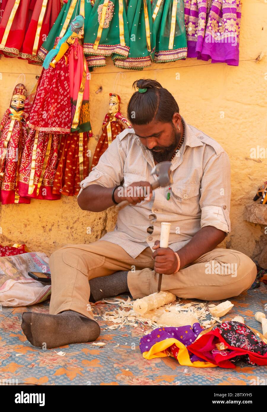 Men at Work, A man making the colorful puppets with wood at Jaisalmer ...