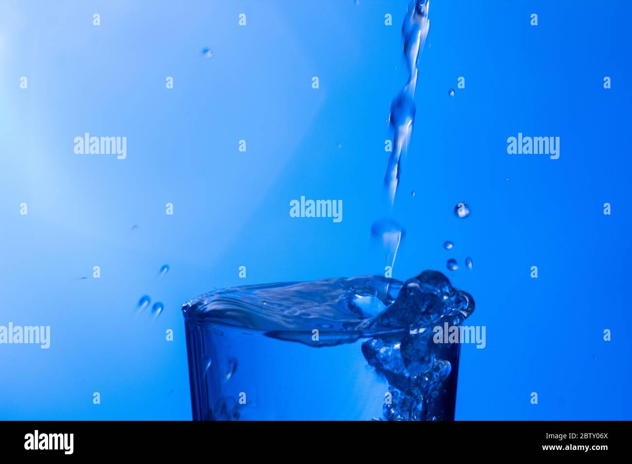 Clear, drinking water falls into a clear glass, healthy, wholesome ...