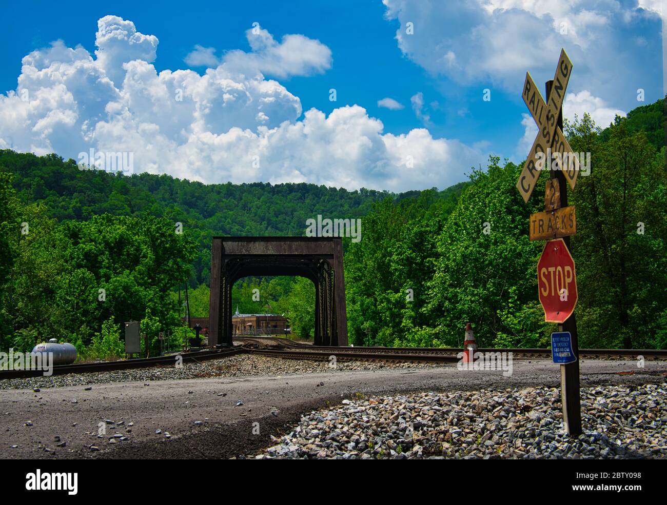 Rail road bridge with blue sky and clouds in background Stock Photo - Alamy