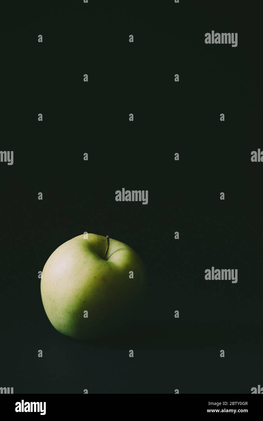 Single apple on black background Stock Photo - Alamy