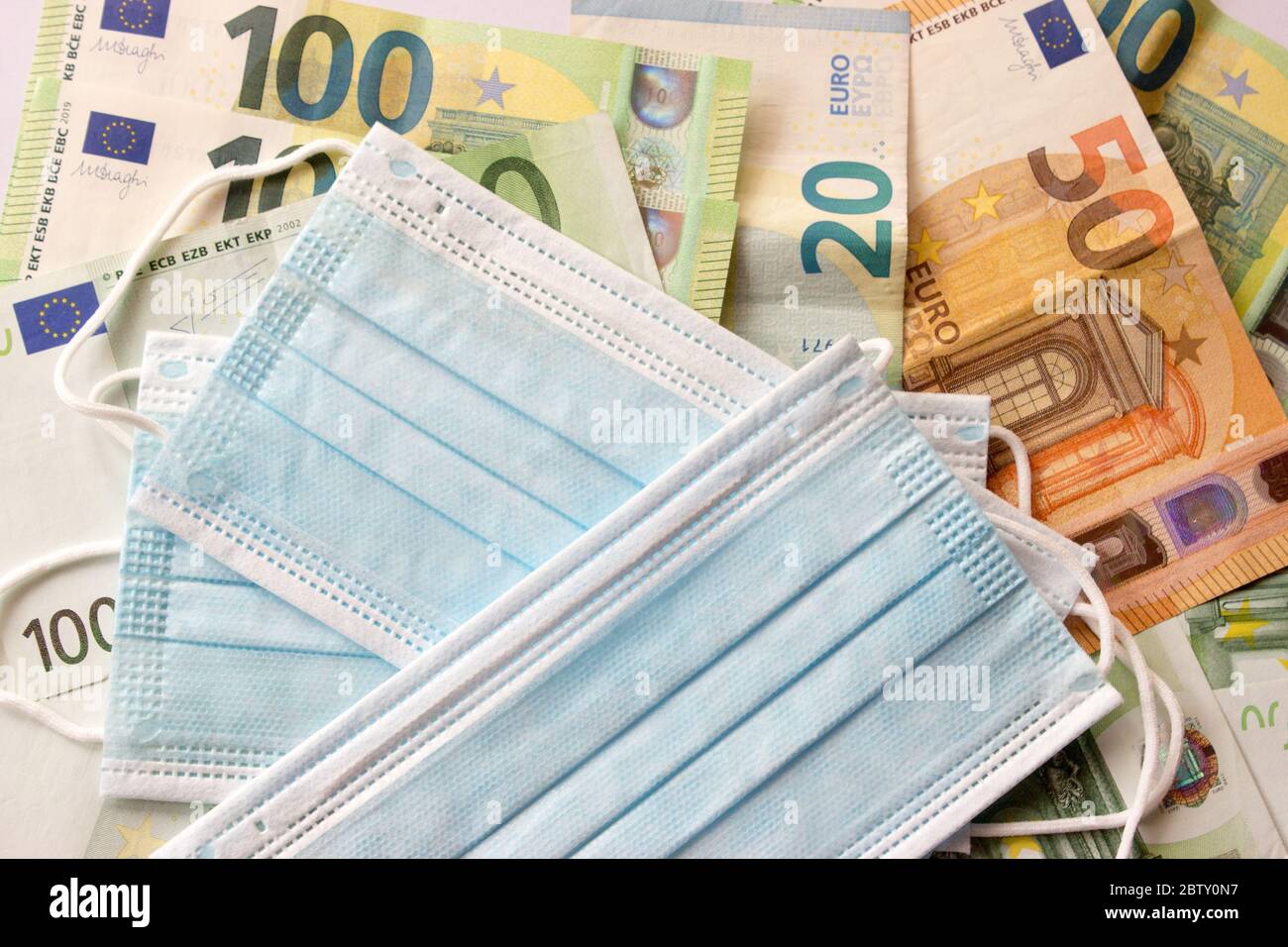 Masks are placed on euro banknotes business money Stock Photo - Alamy