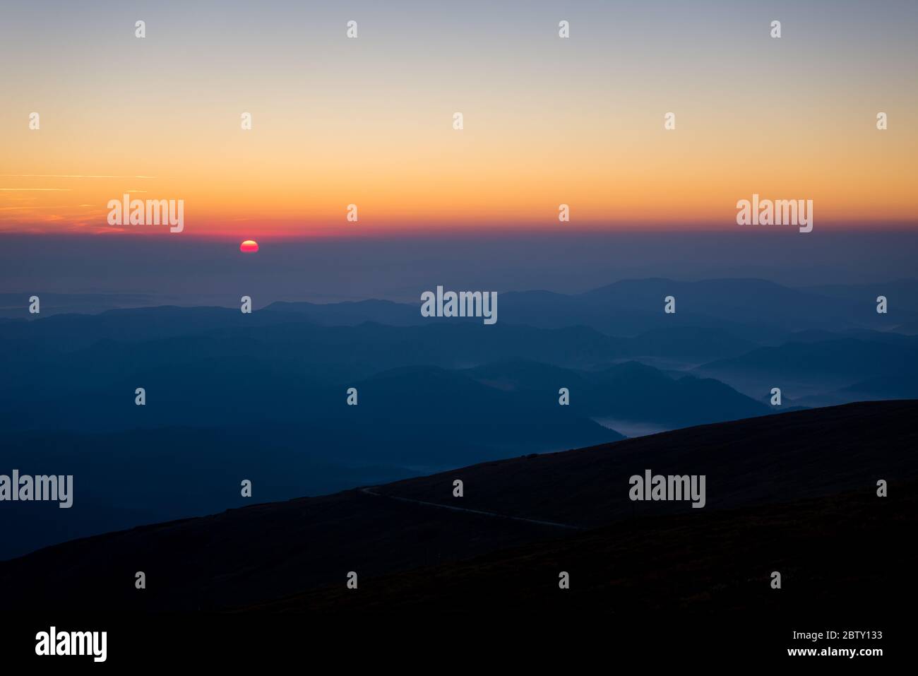 Beautiful sunrise over the mountains, long distance Stock Photo - Alamy