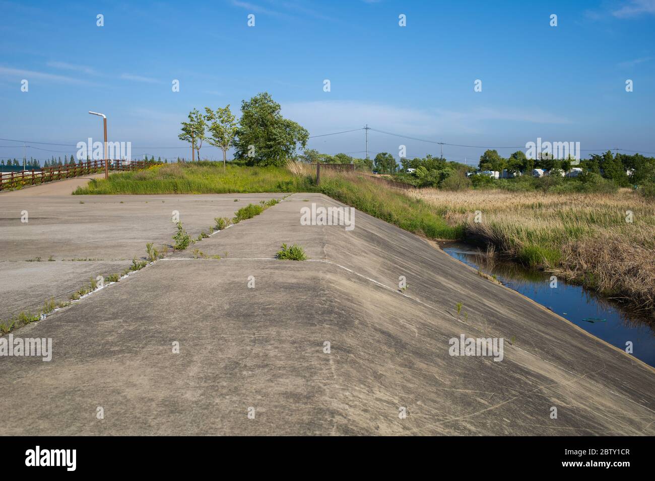 concrete embankment and surrounding meadow Stock Photo - Alamy