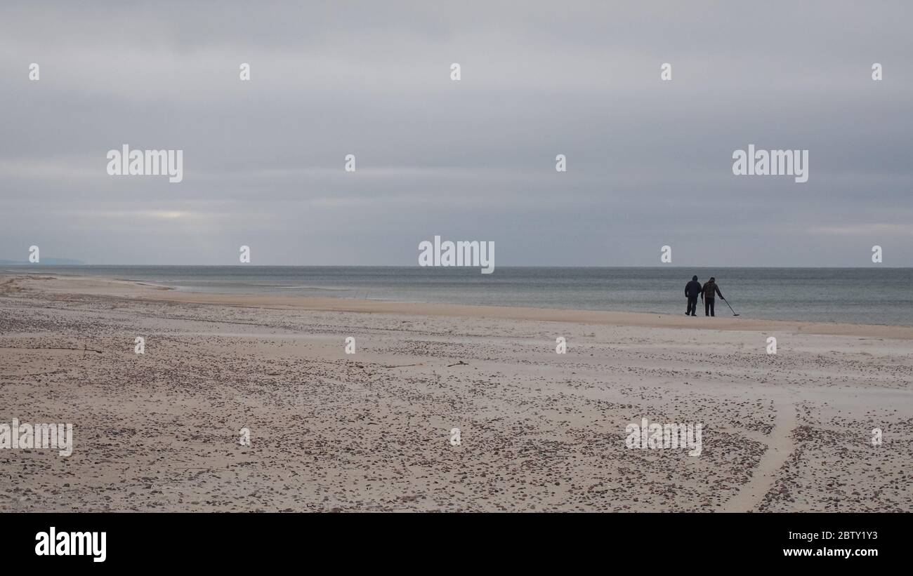 Figures of men on the beach hi-res stock photography and images - Alamy