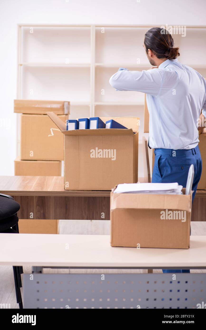 Young employee in relocation concept Stock Photo - Alamy