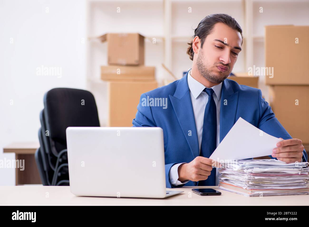 Young employee in relocation concept Stock Photo - Alamy