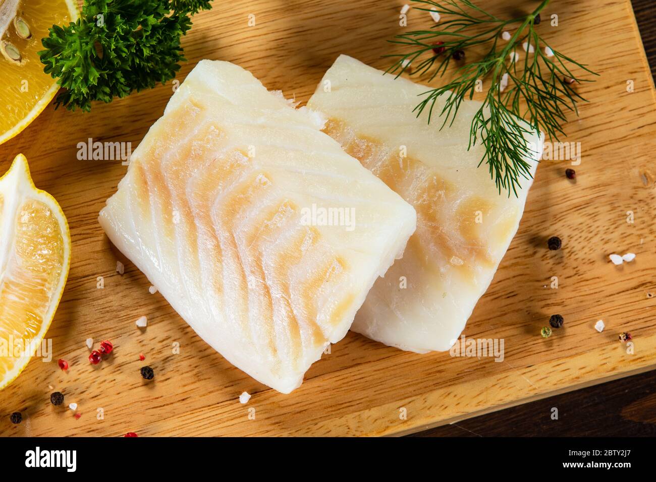 Fresh raw cod on wooden board Stock Photo - Alamy