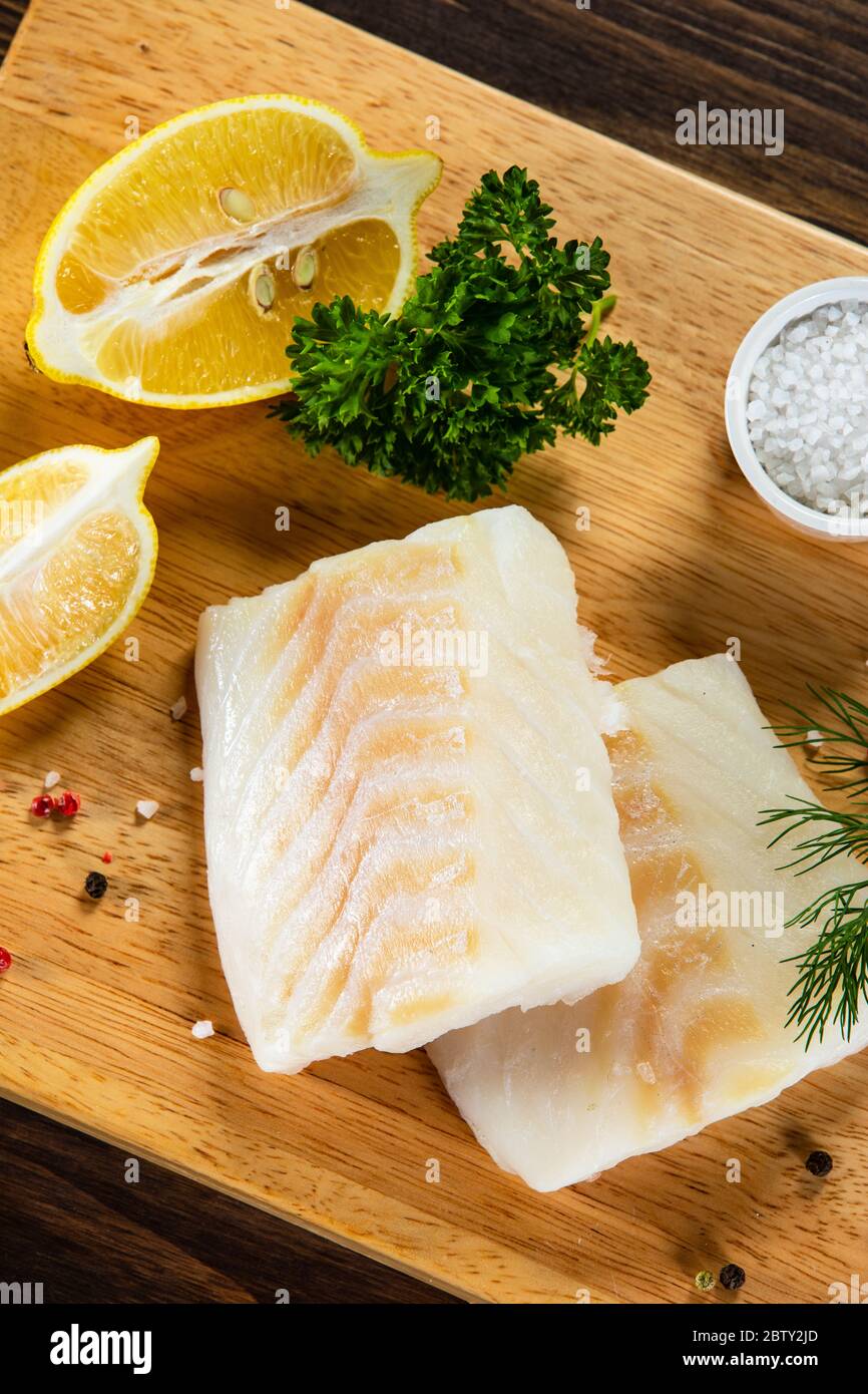 Fresh raw cod on wooden board Stock Photo - Alamy