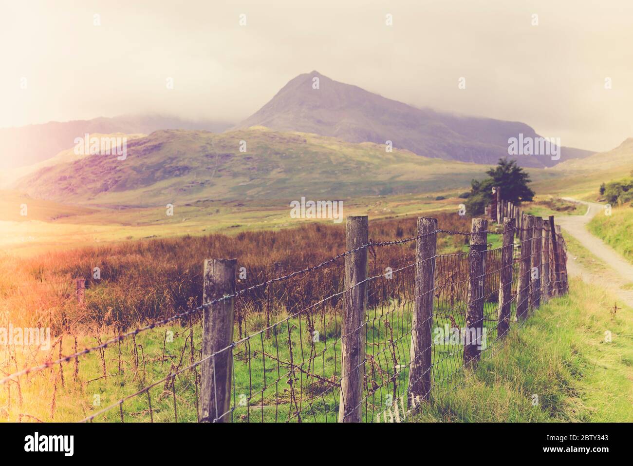Retro view of Mount Snowdon, North Wales in summer mist, from winding ...