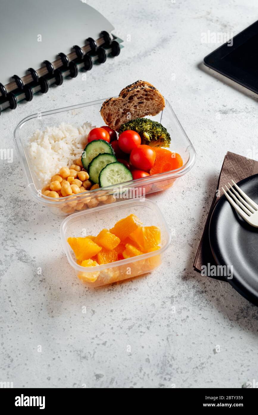 Healthy food in lunch box, on working table with laptop Stock Photo - Alamy