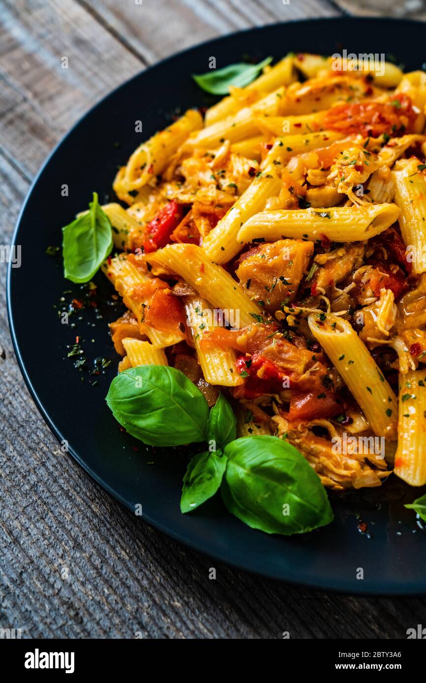 Pasta with tomato sauce and vegtables on wooden table Stock Photo - Alamy