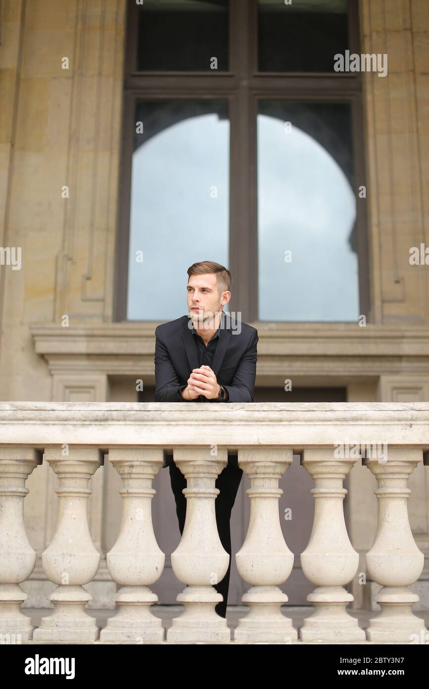 Boy leaning railing outdoors hi-res stock photography and images - Alamy