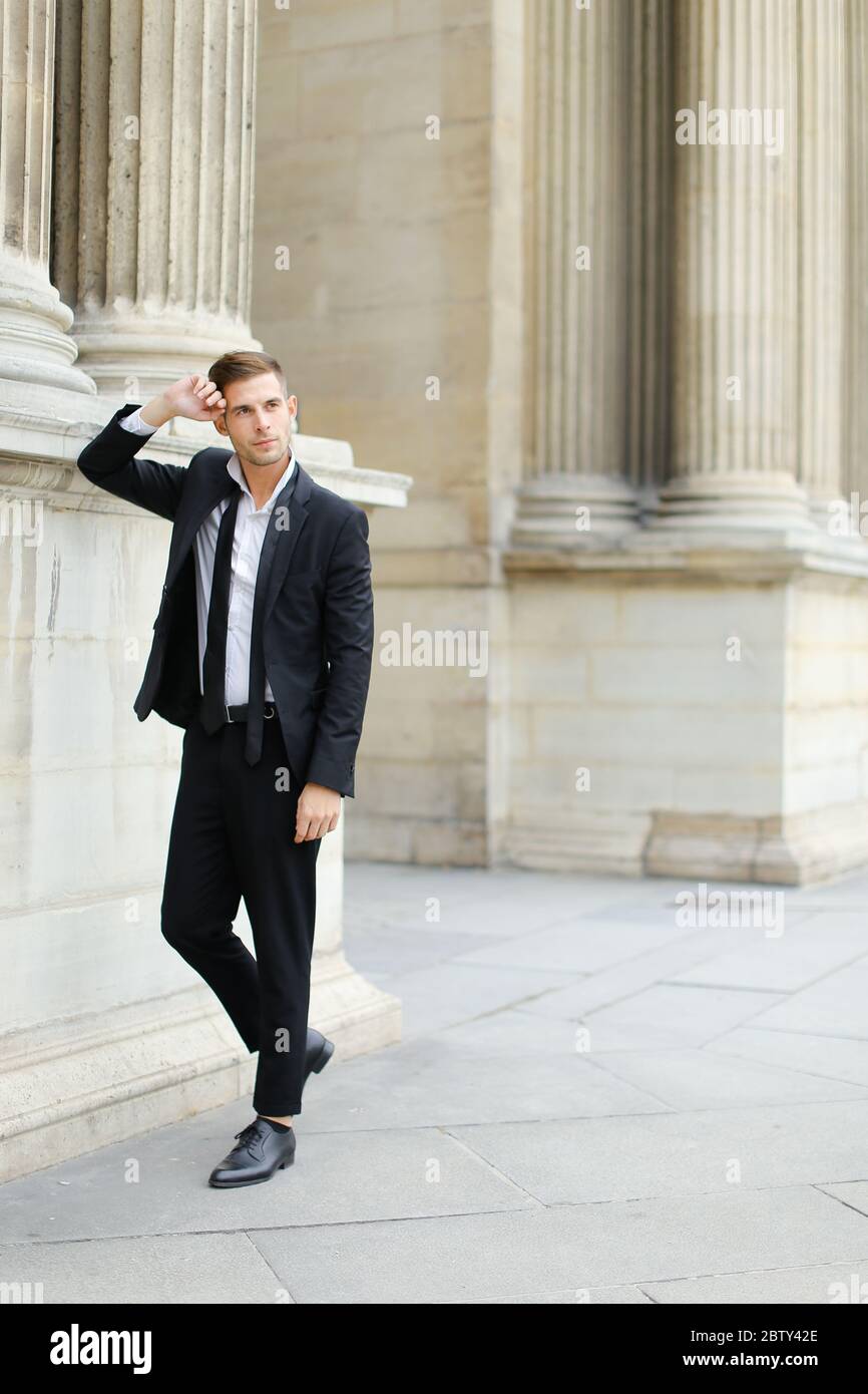 Young man leaning on column hi-res stock photography and images - Alamy