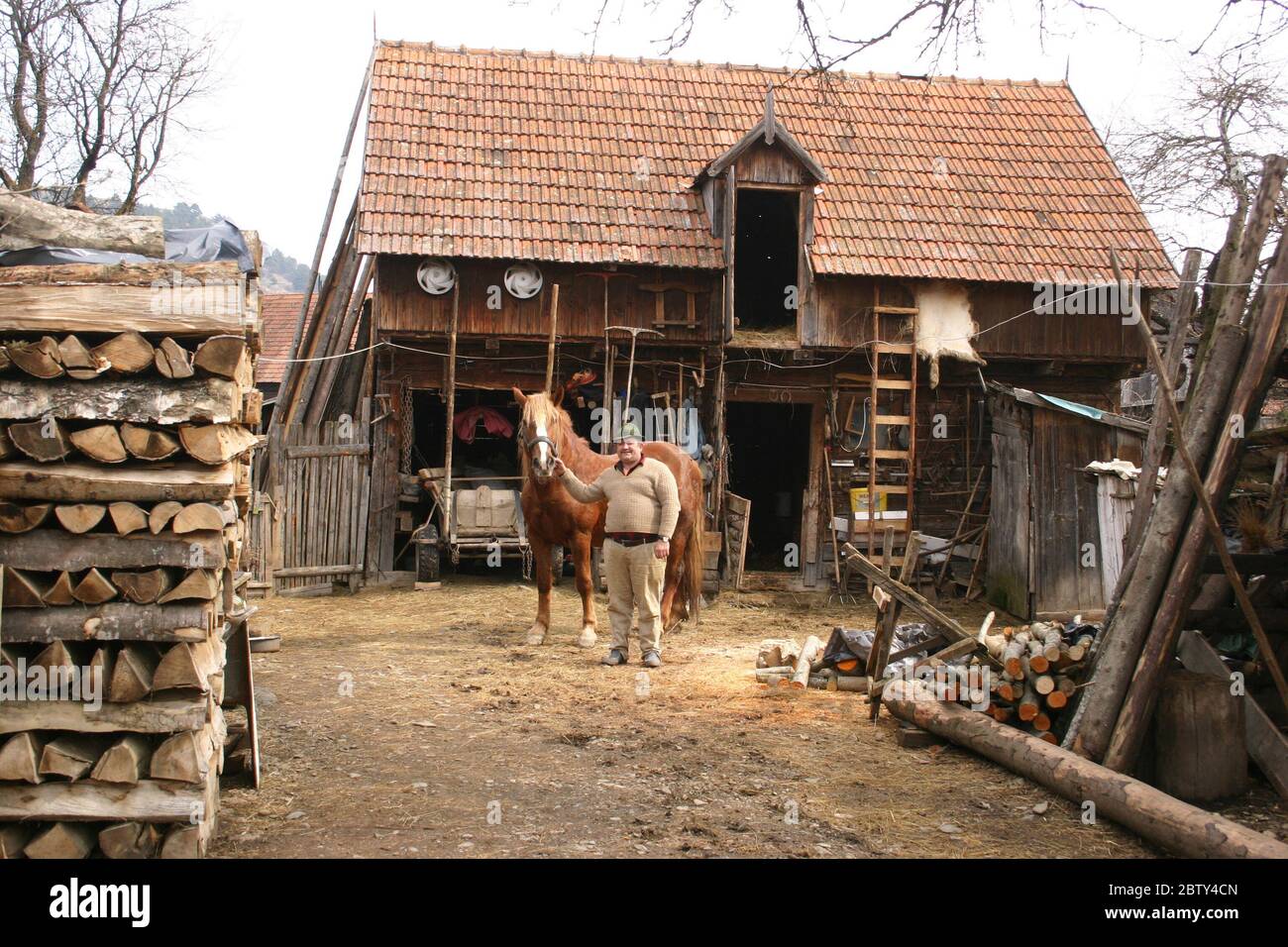 Traditional courtyard with barn in Covasna County, Romania. Owner with ...
