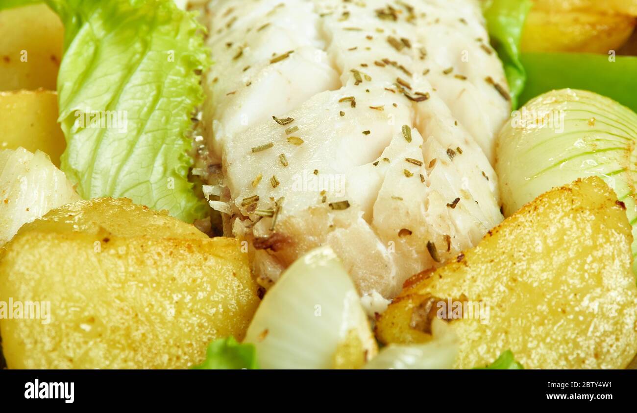 Sizzling cod, Baked fish fillet with potatoes peppers Stock Photo - Alamy
