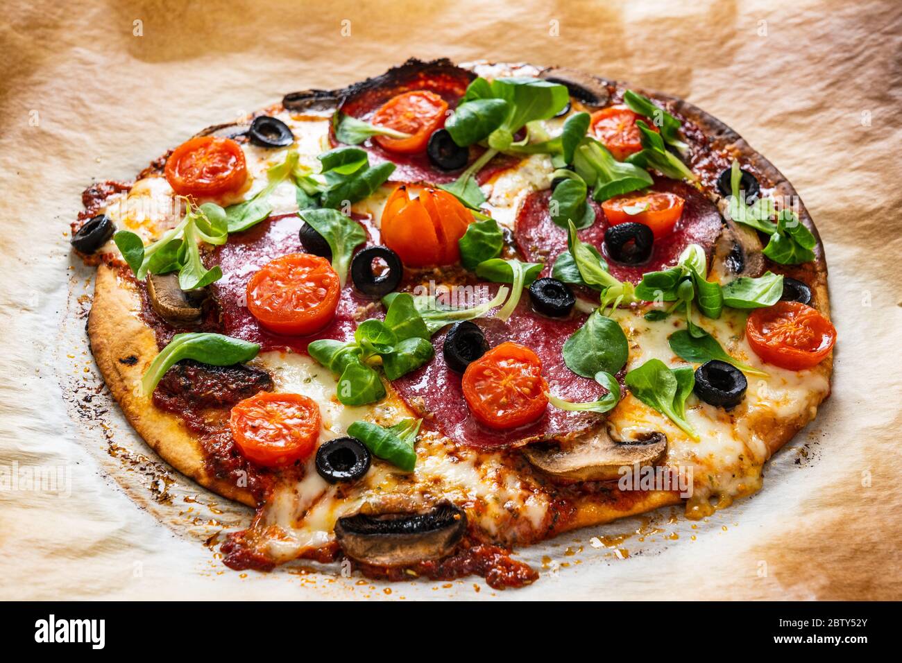 Pizza on baking paper Stock Photo - Alamy
