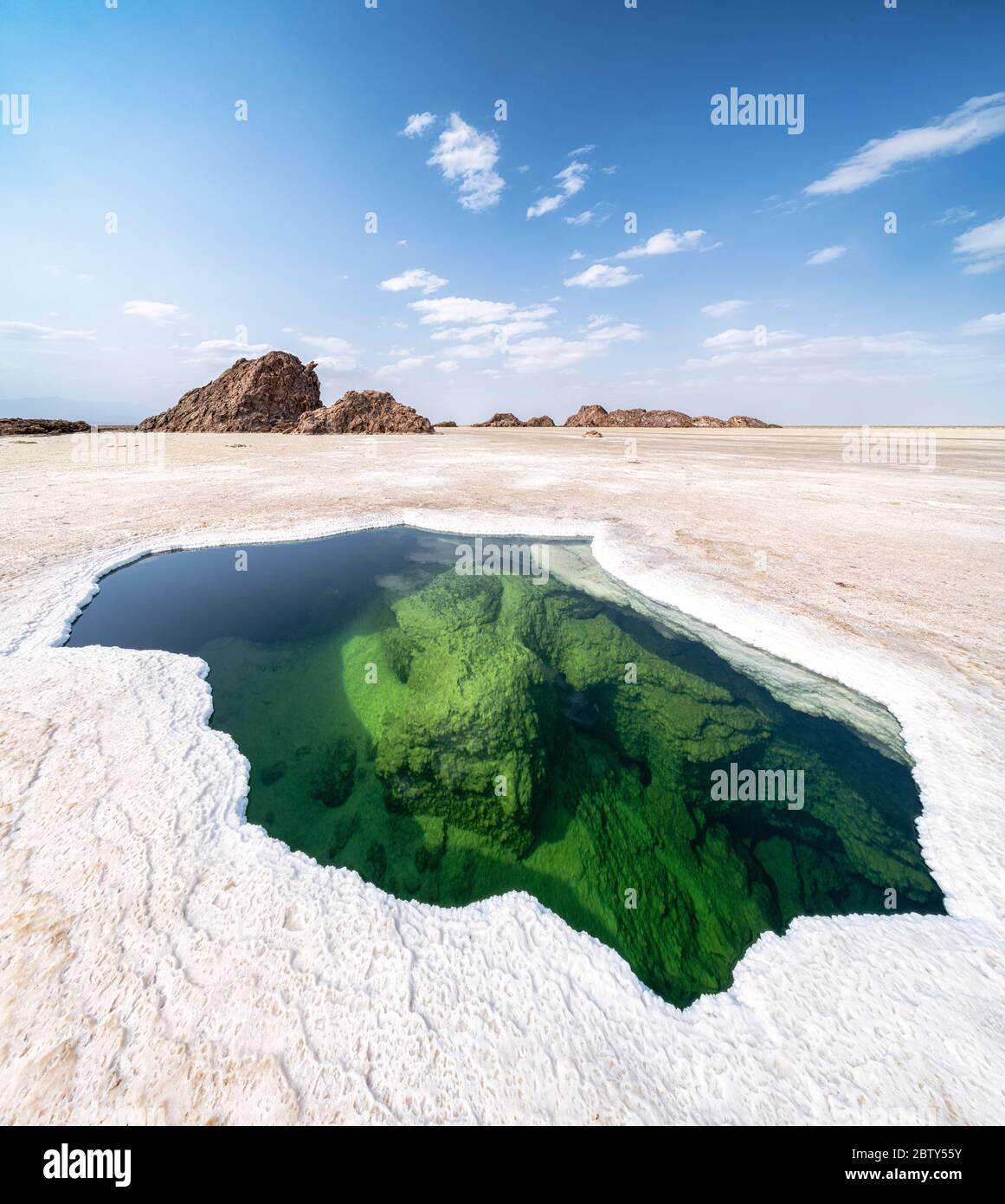 Panoramic of the transparent water of natural pond in the salt pan ...
