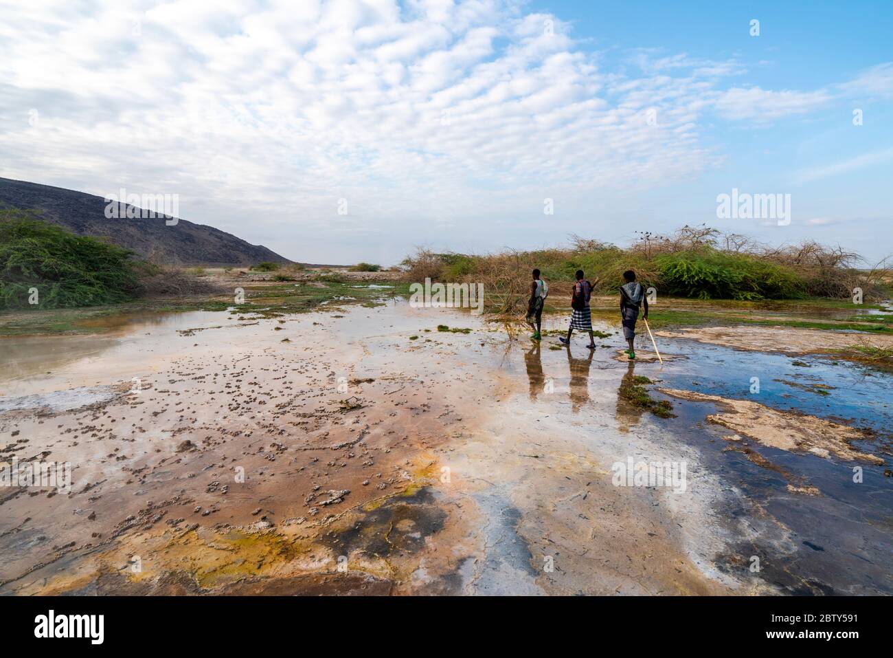 Afar men walking towards Ala Lobet (Alol Bet) geyser, Semera, Afar ...