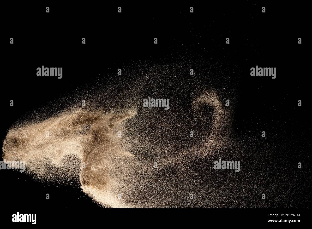 Brown colored sand splash.Dry river sand explosion isolated on black ...