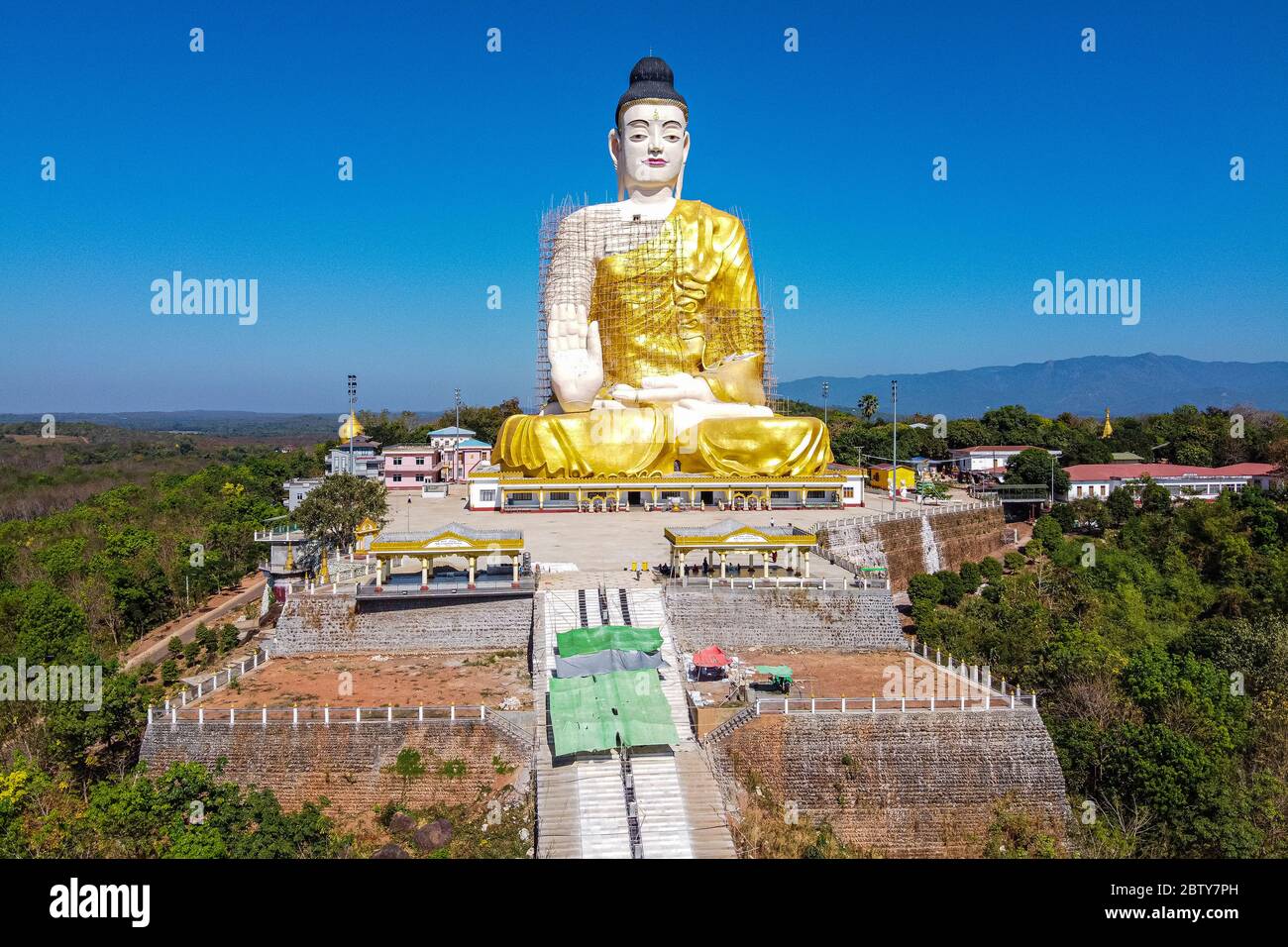 Aerial of a giant sitting Buddha below the Kyaiktiyo Pagoda (Golden ...
