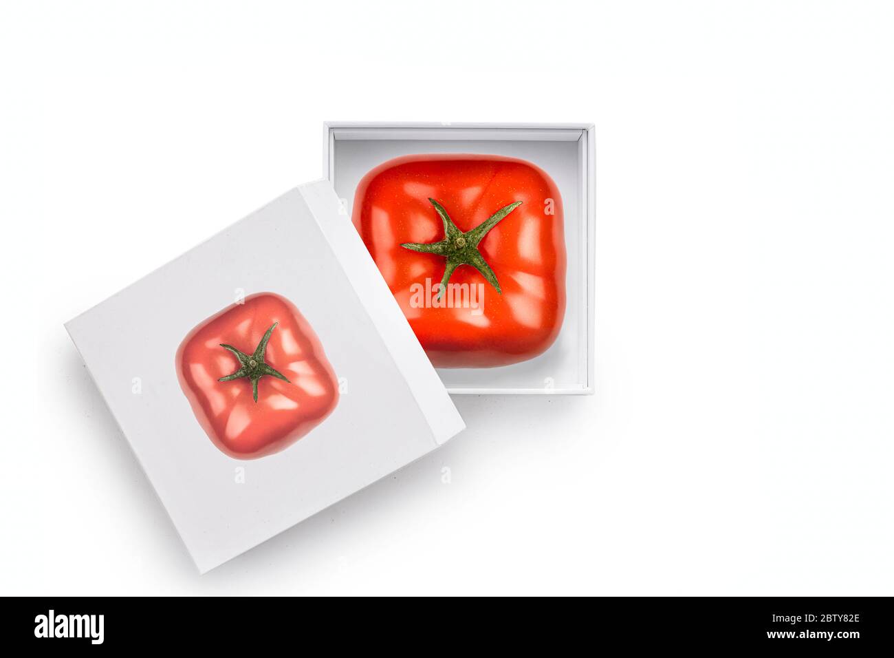 Square tomato in a white box. A gift for a vegan and a lover of healthy ...