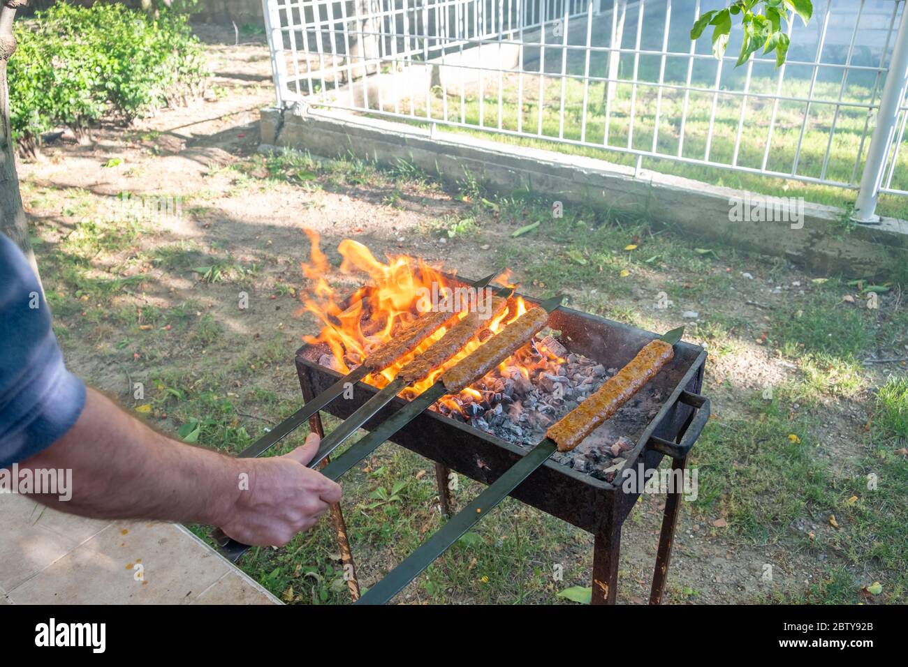 Traditional Turkish Adana Kebap on the grill with skewers for dinner ...