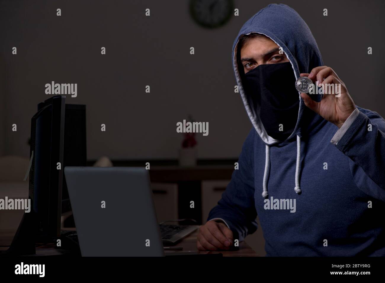 Male hacker hacking security firewall late in the office Stock Photo ...