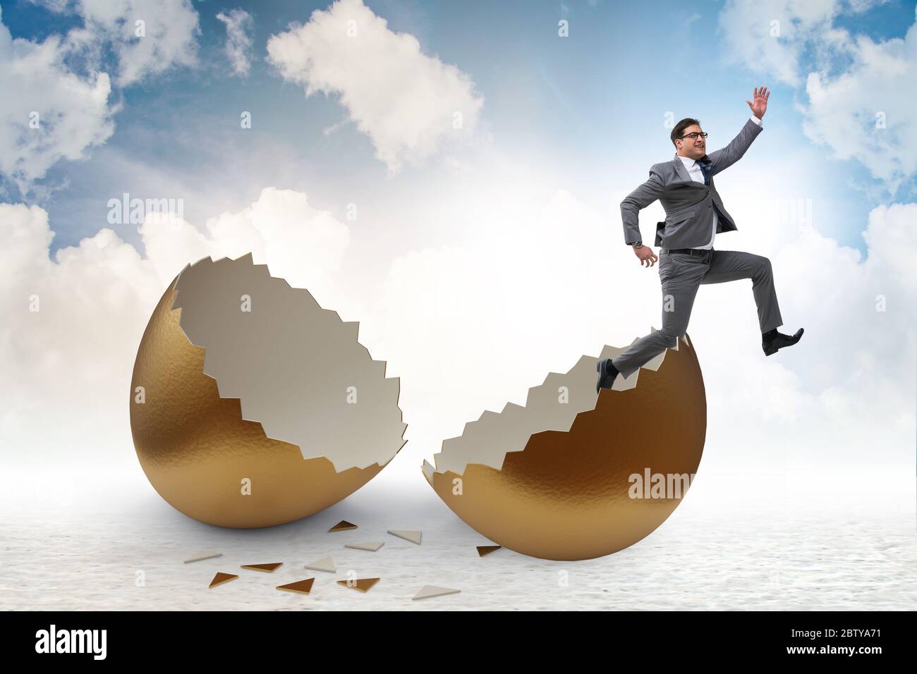 Businessman breaking out of the golden egg Stock Photo - Alamy