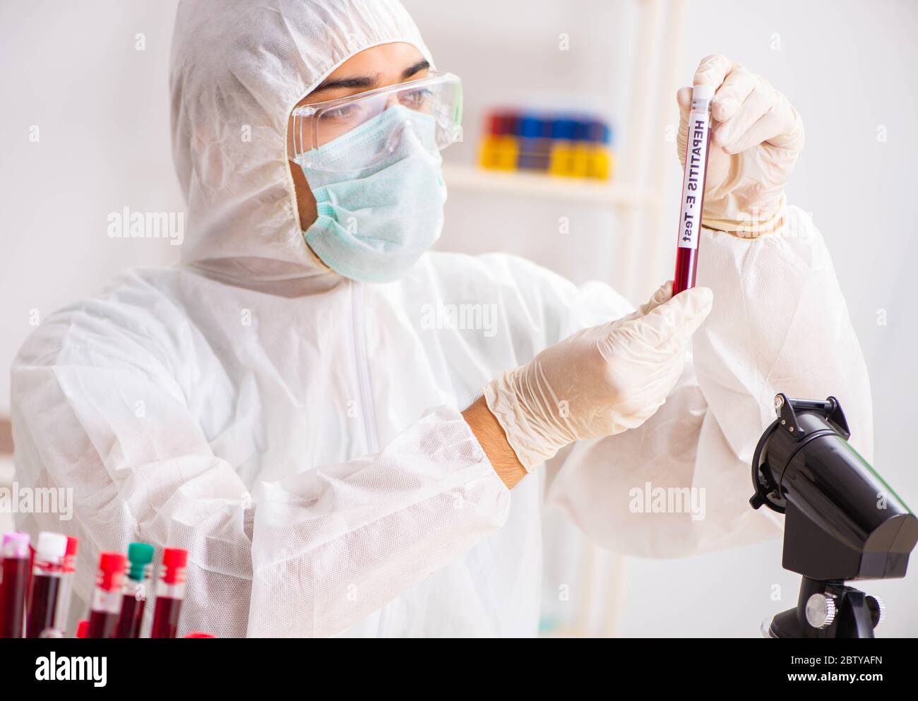The young handsome lab assistant testing blood samples in hospital ...