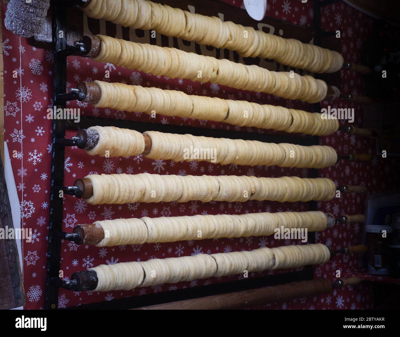 Kurtos kalacs or chimney cakes, preparing cooking on charcoal grill ...