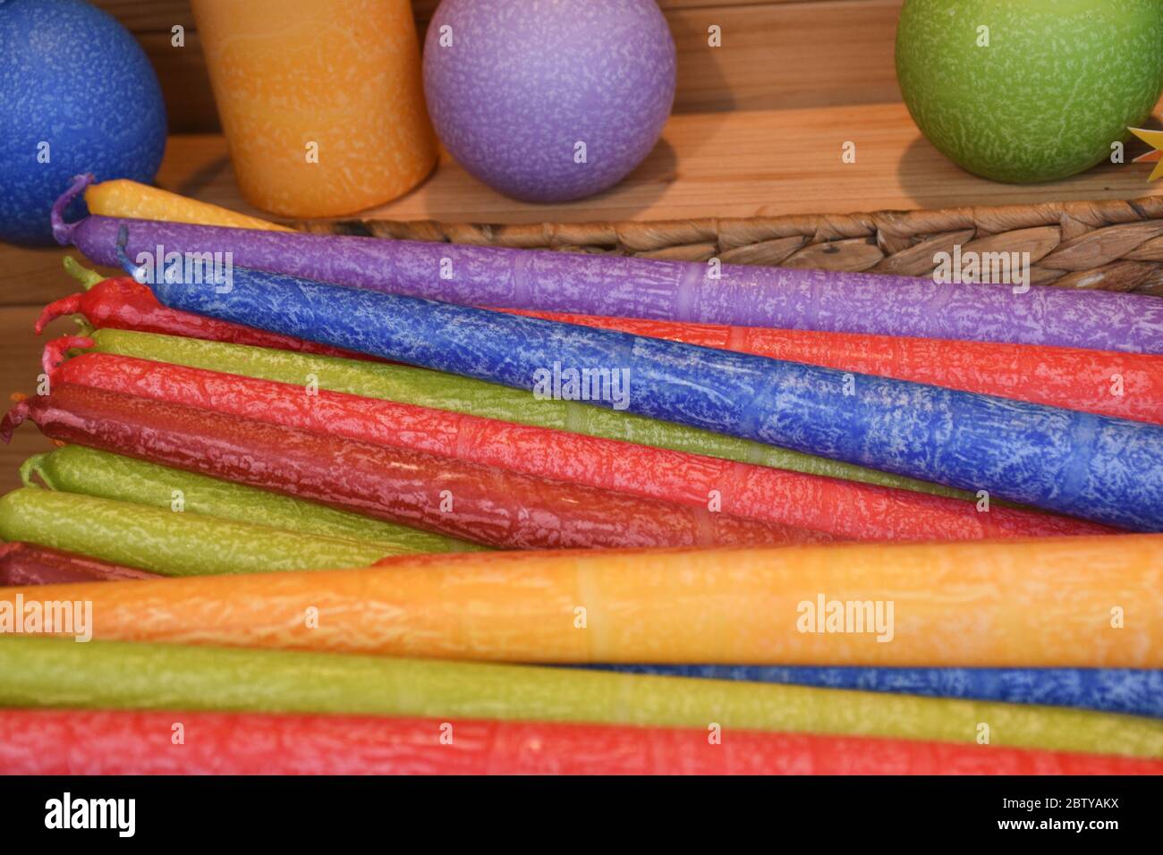 Many multicolored colorful red orange yellow paraffin stick candles ...