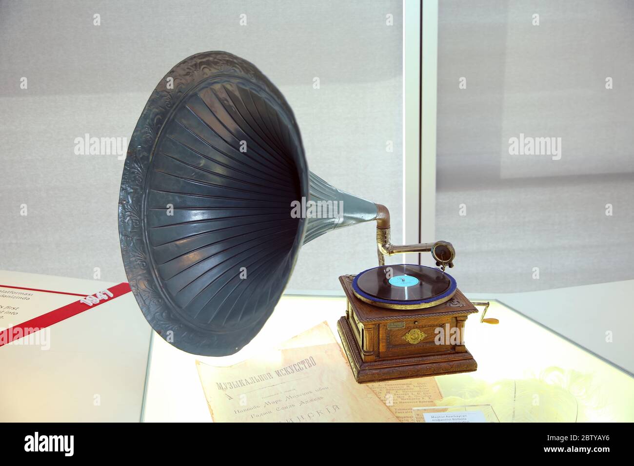 Old gramophone with plate or vinyl disk on wooden box. Antique brass ...