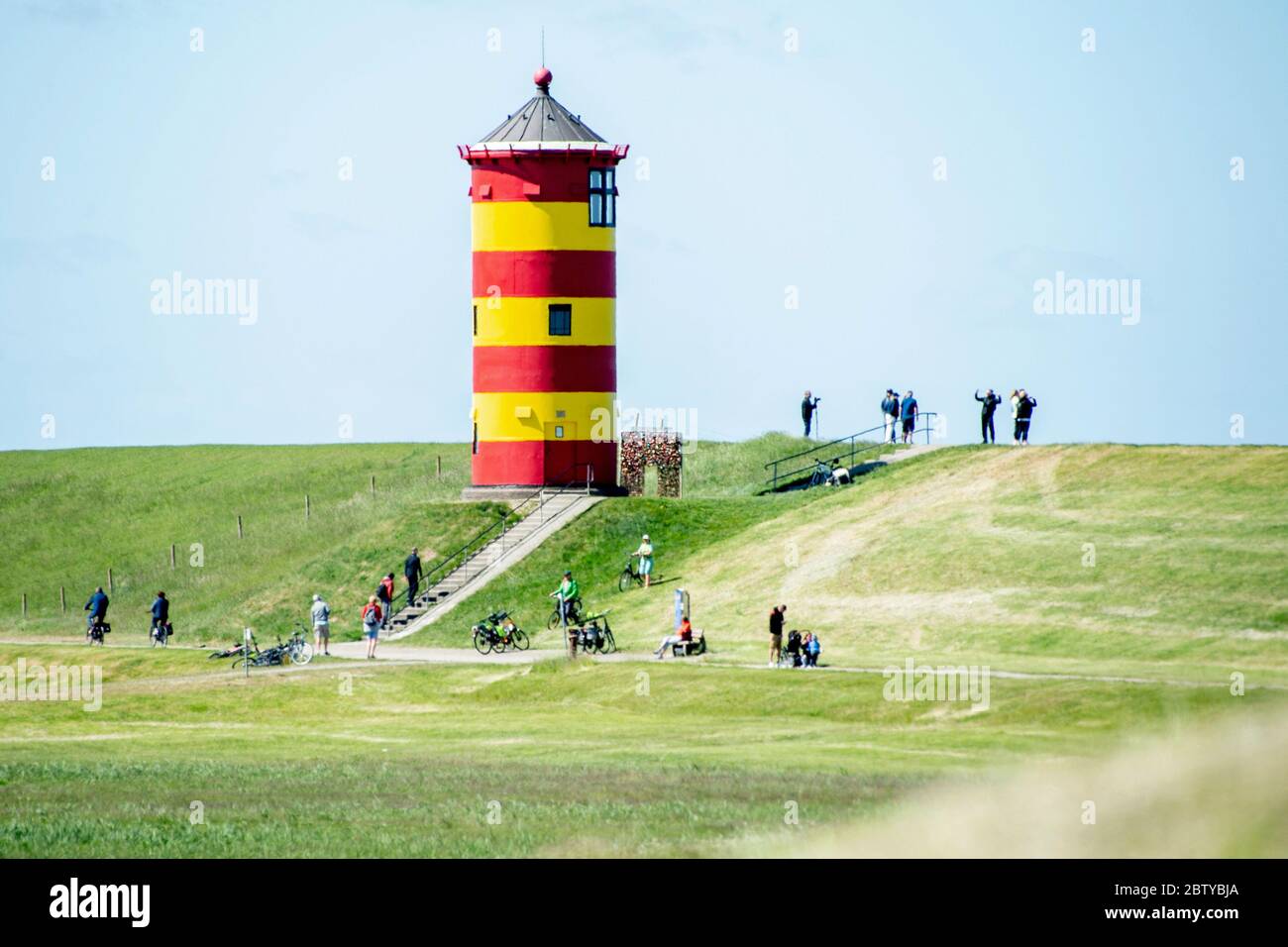 Pilsum, Germany. 28th May, 2020. Tourists walk on the dike in front of ...