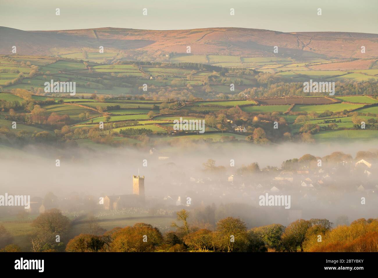 Misty winter morning view towards the church and Dartmoor village of ...