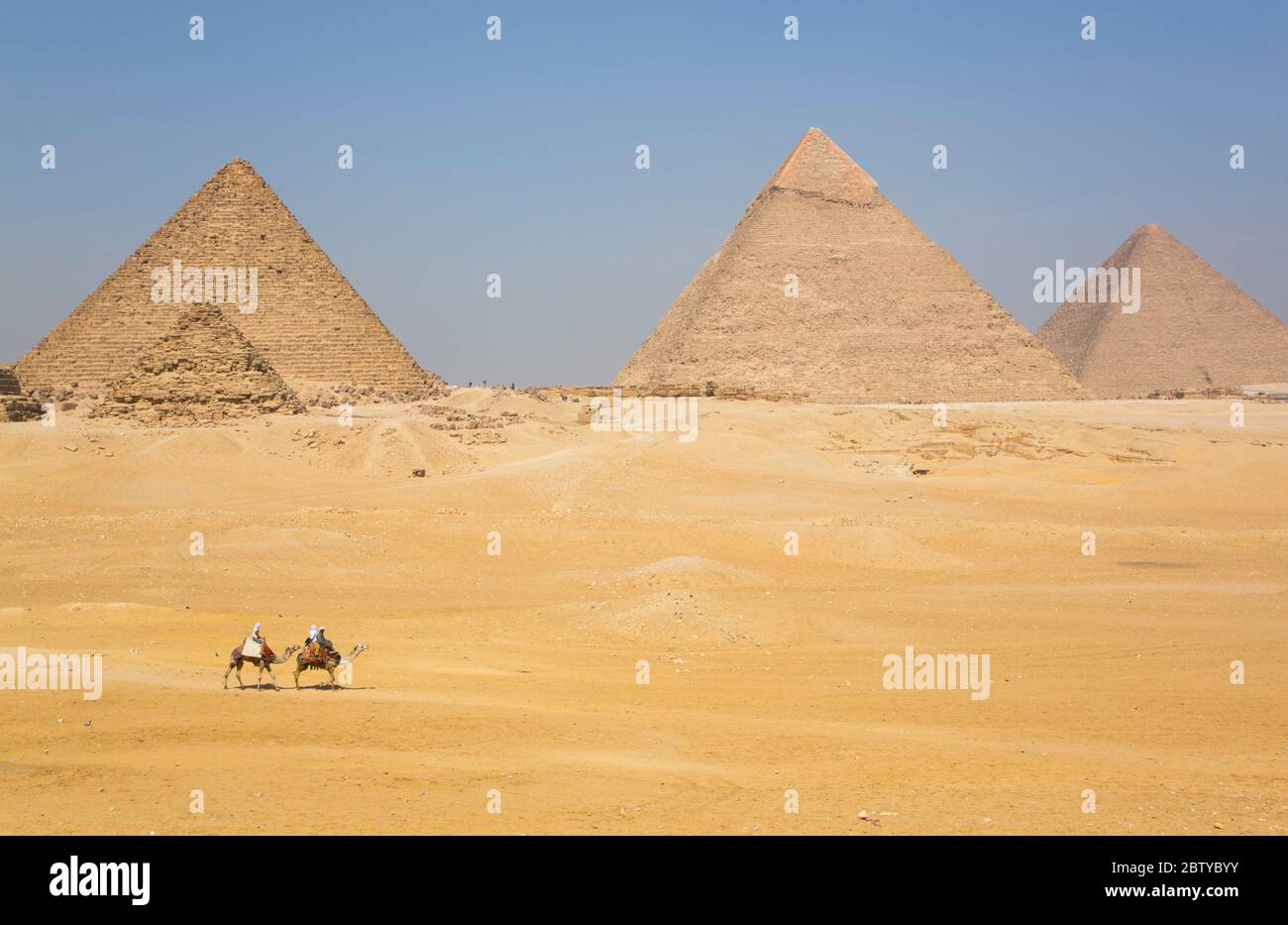 Tourists riding camels, Great Pyramids of Giza, UNESCO World Heritage ...