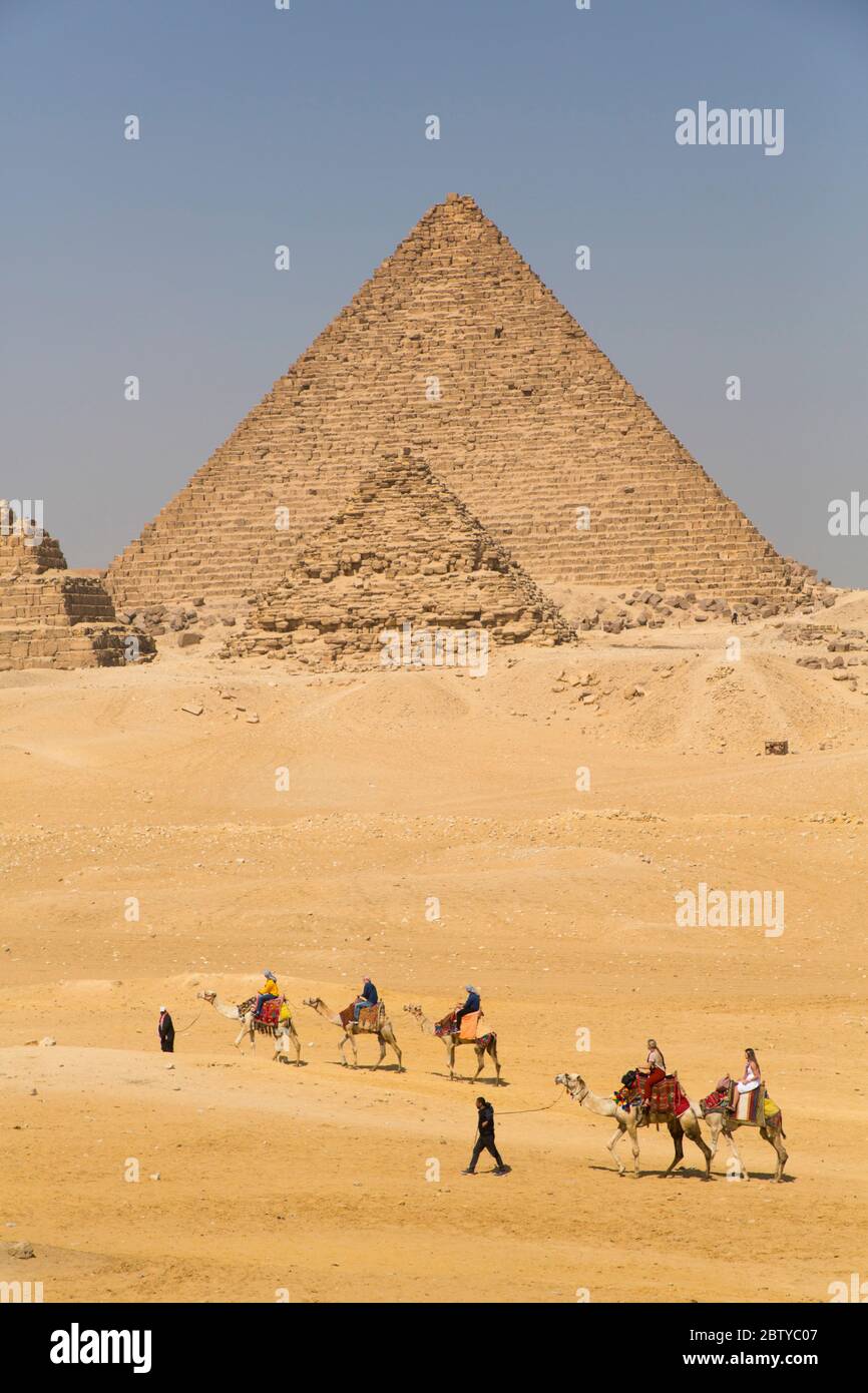 Tourists riding camels, Great Pyramids of Giza, UNESCO World Heritage ...