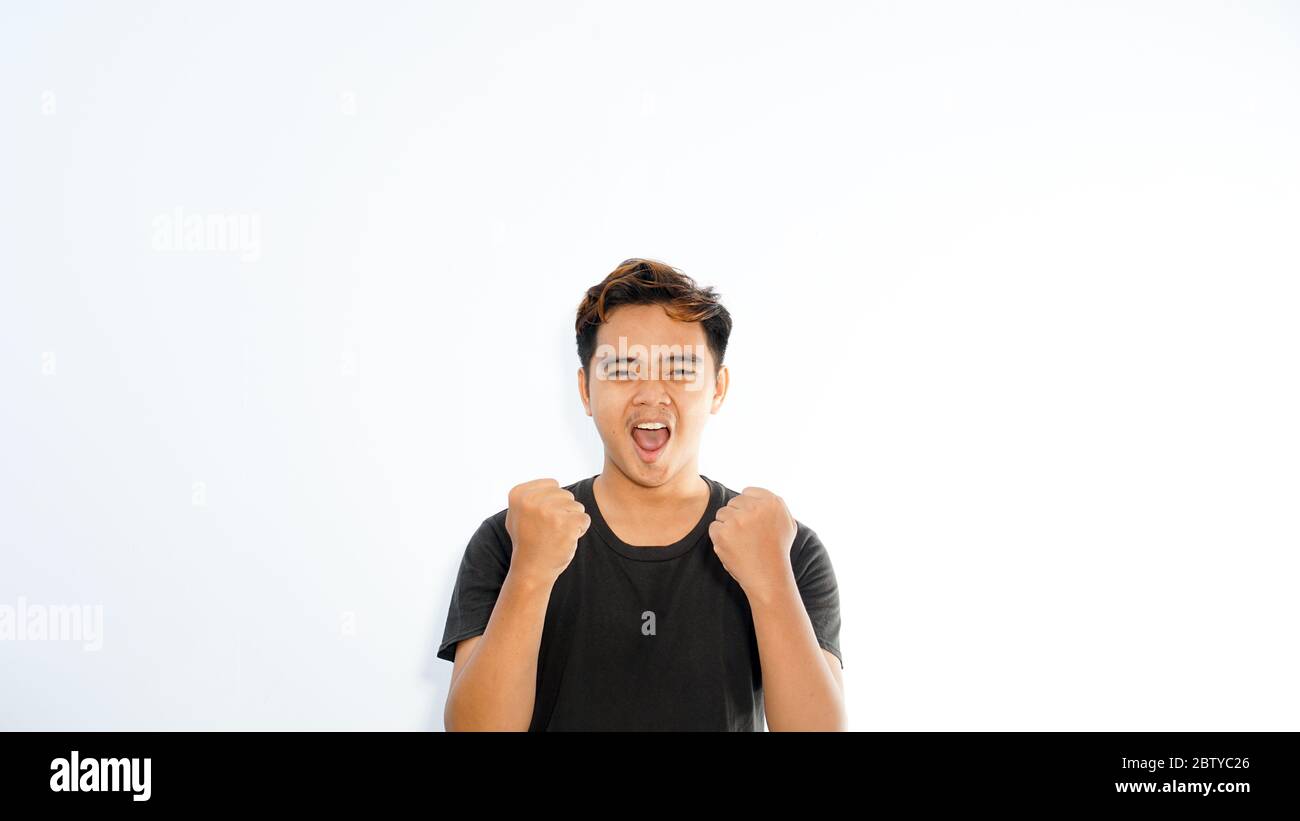 Asian man raising his hand celebrated and saying yes. Competition ...