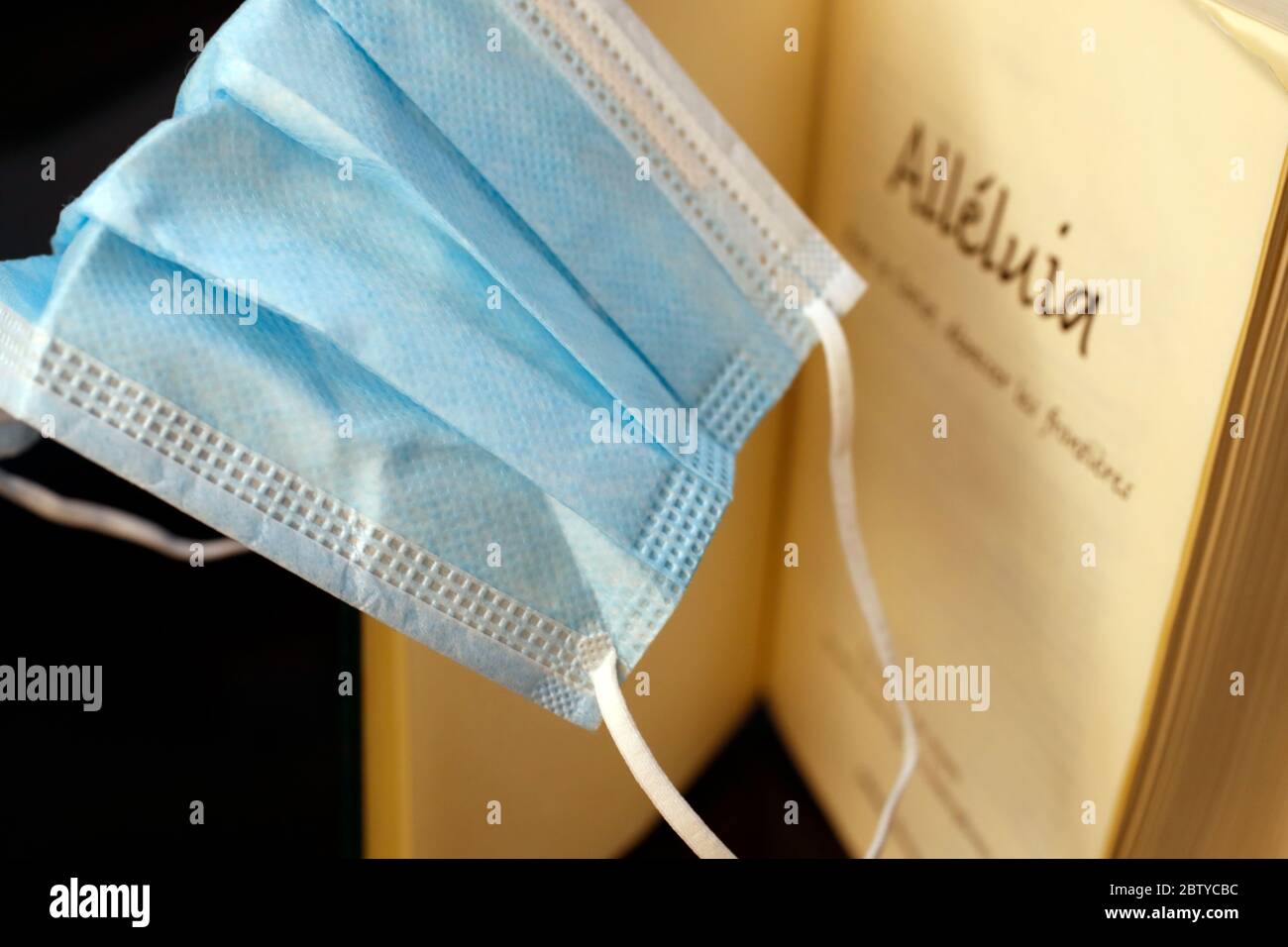 Religion and coronavirus (COVID-19), Bible and disposable surgical mask ...