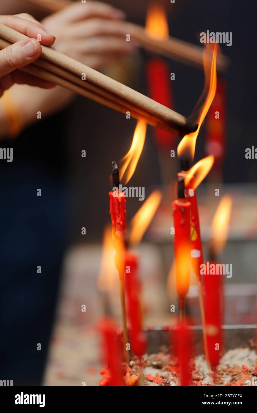 Chinese man burning incense and praying to a prosperous future, Guan Di ...