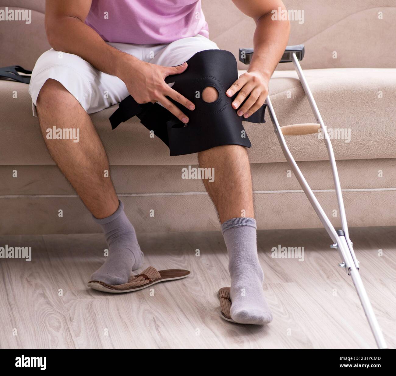 The injured man recovering at home from sports injury Stock Photo - Alamy