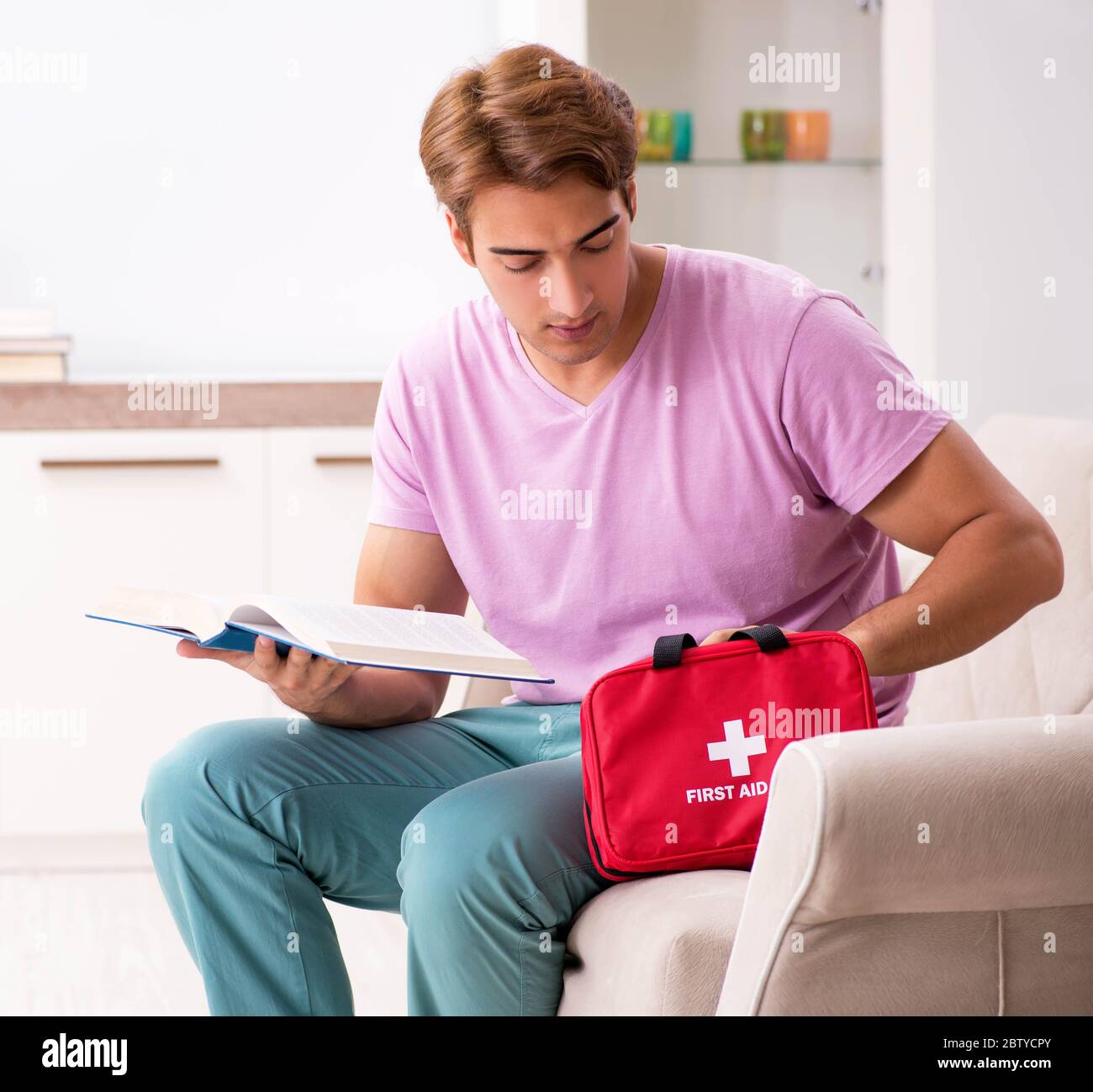 The sick man at home with first aid kit Stock Photo - Alamy