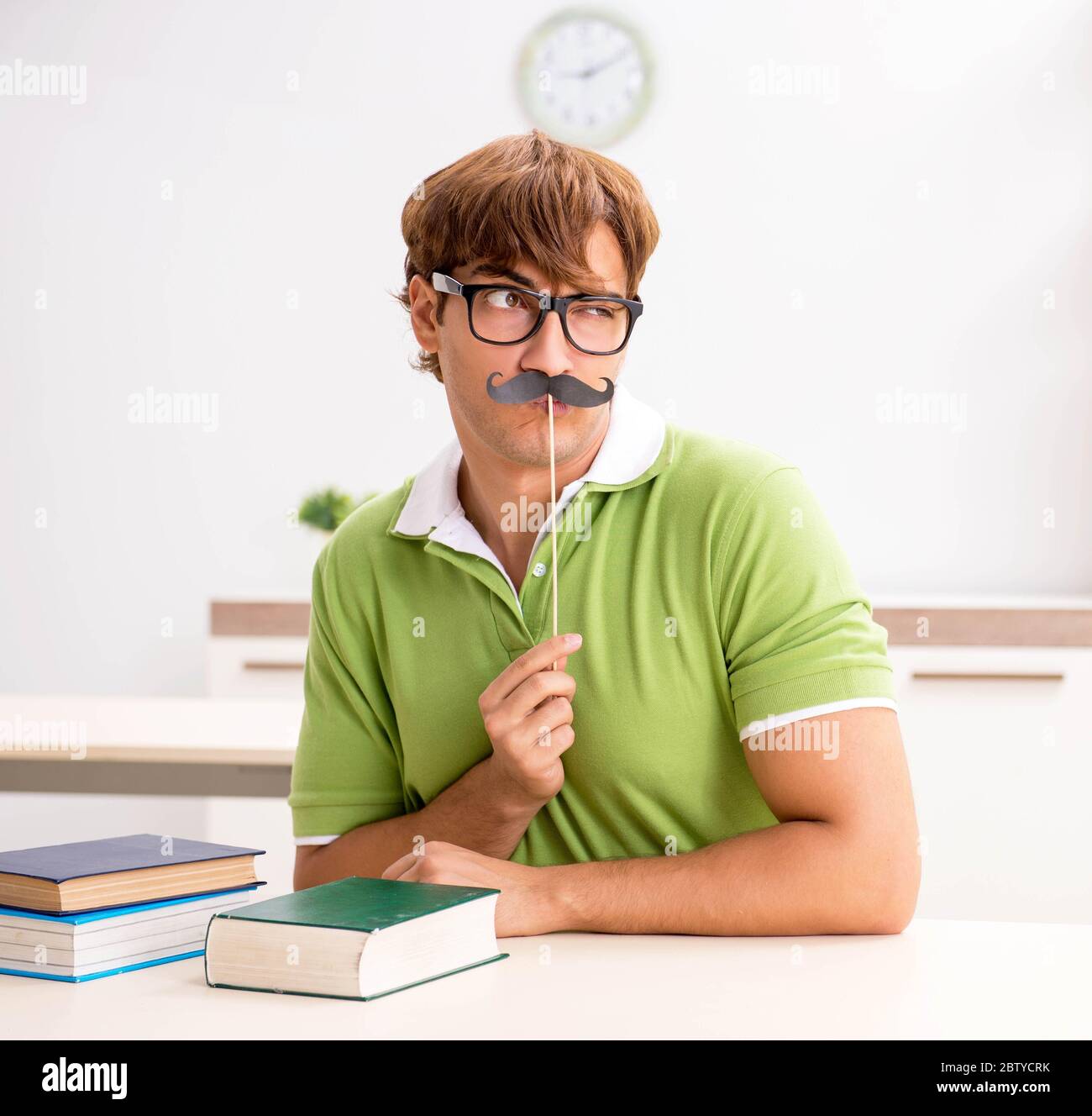 The student with fake moustache reading book Stock Photo - Alamy