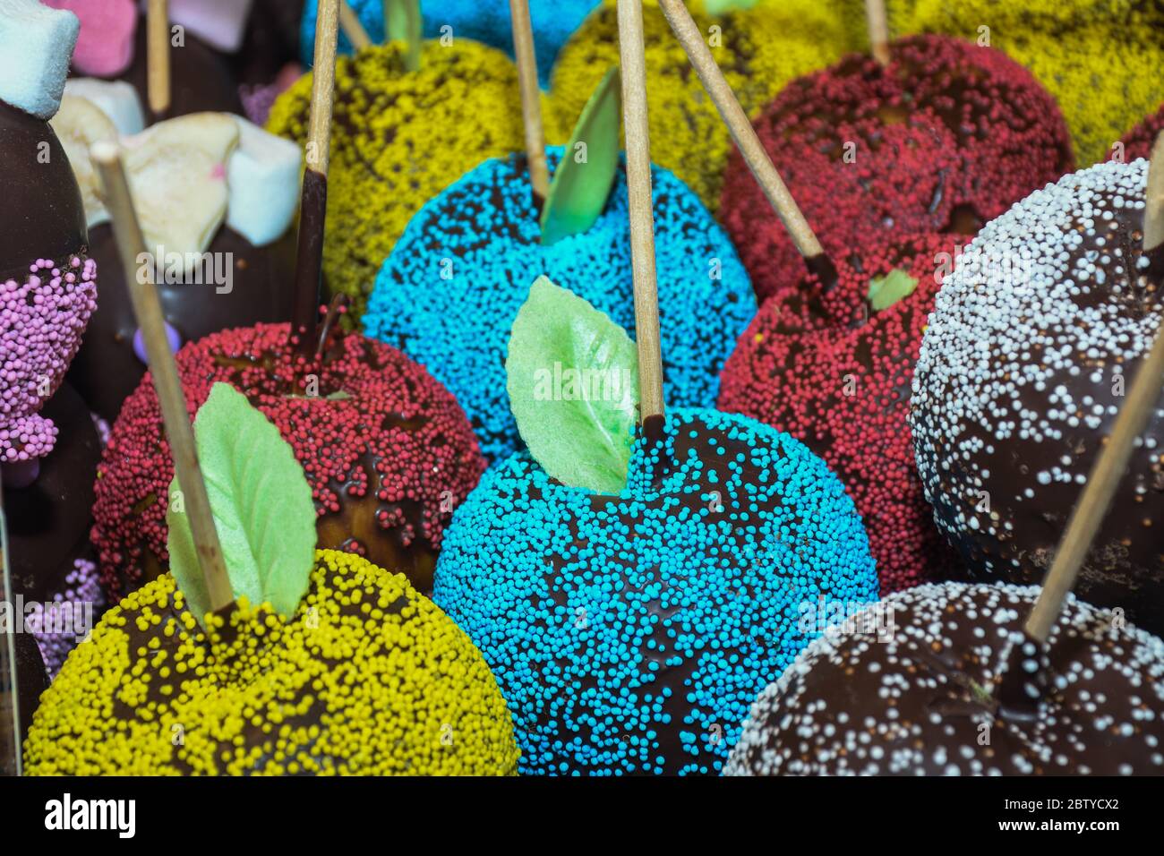 Sweet glazed red toffee candy apples on sticks for sale on farmer ...
