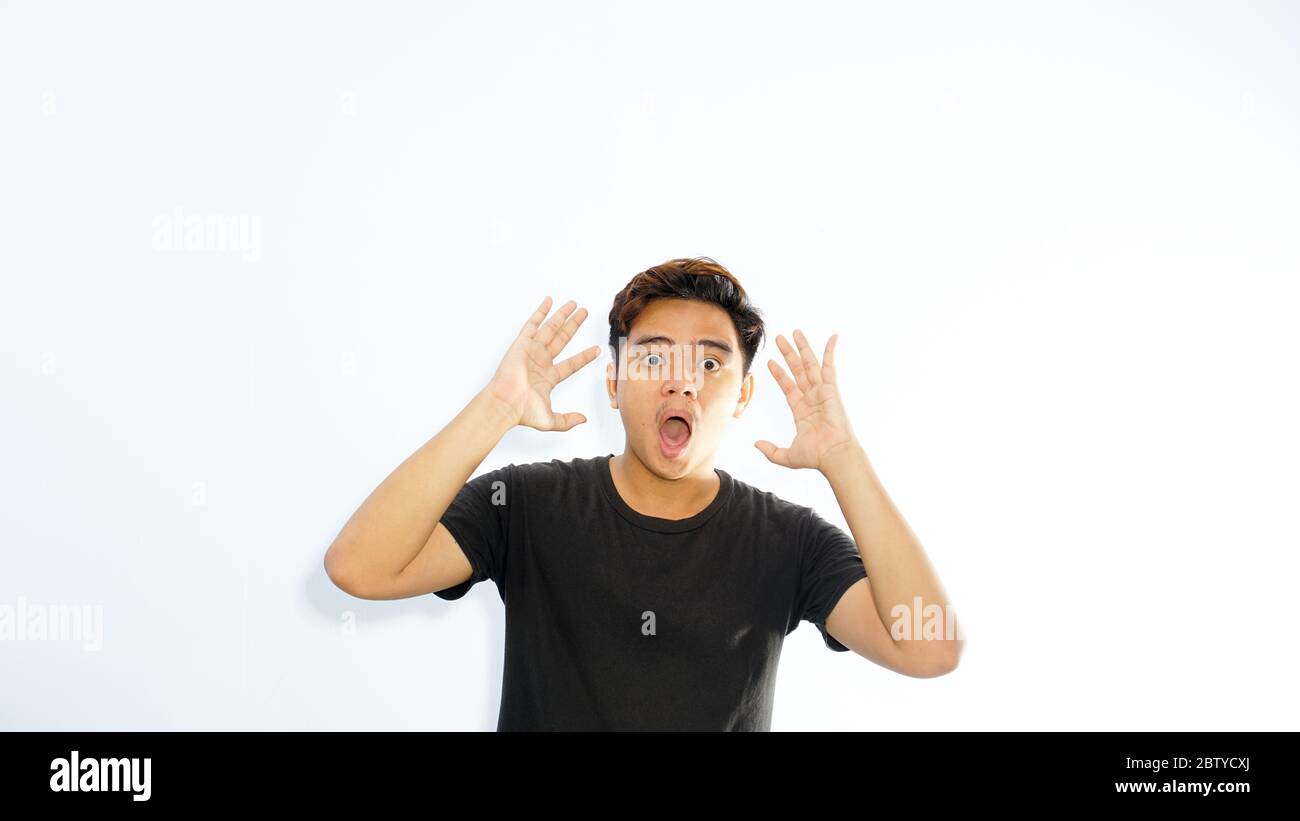 Young hispanic Asian man over isolated white background afraid and ...